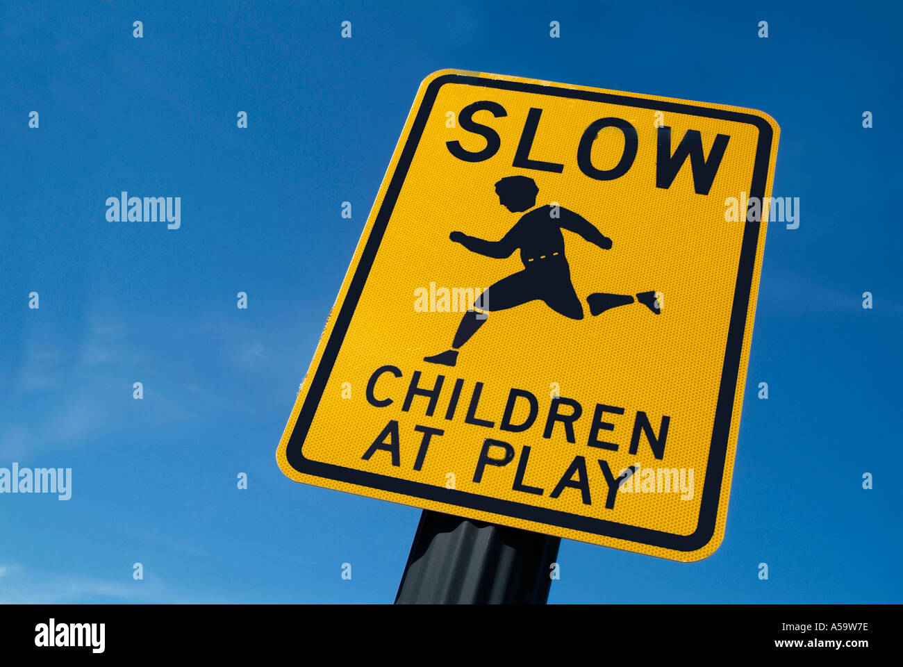 Slow children at play sign next to street at a small park Stock Photo ...