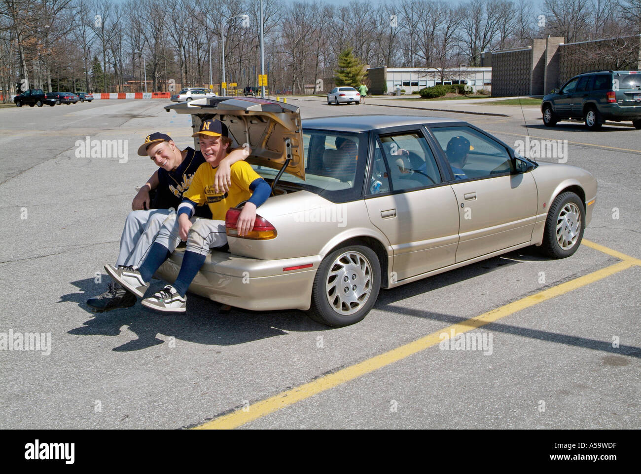 Students ride in the trunk of a car Stock Photo - Alamy