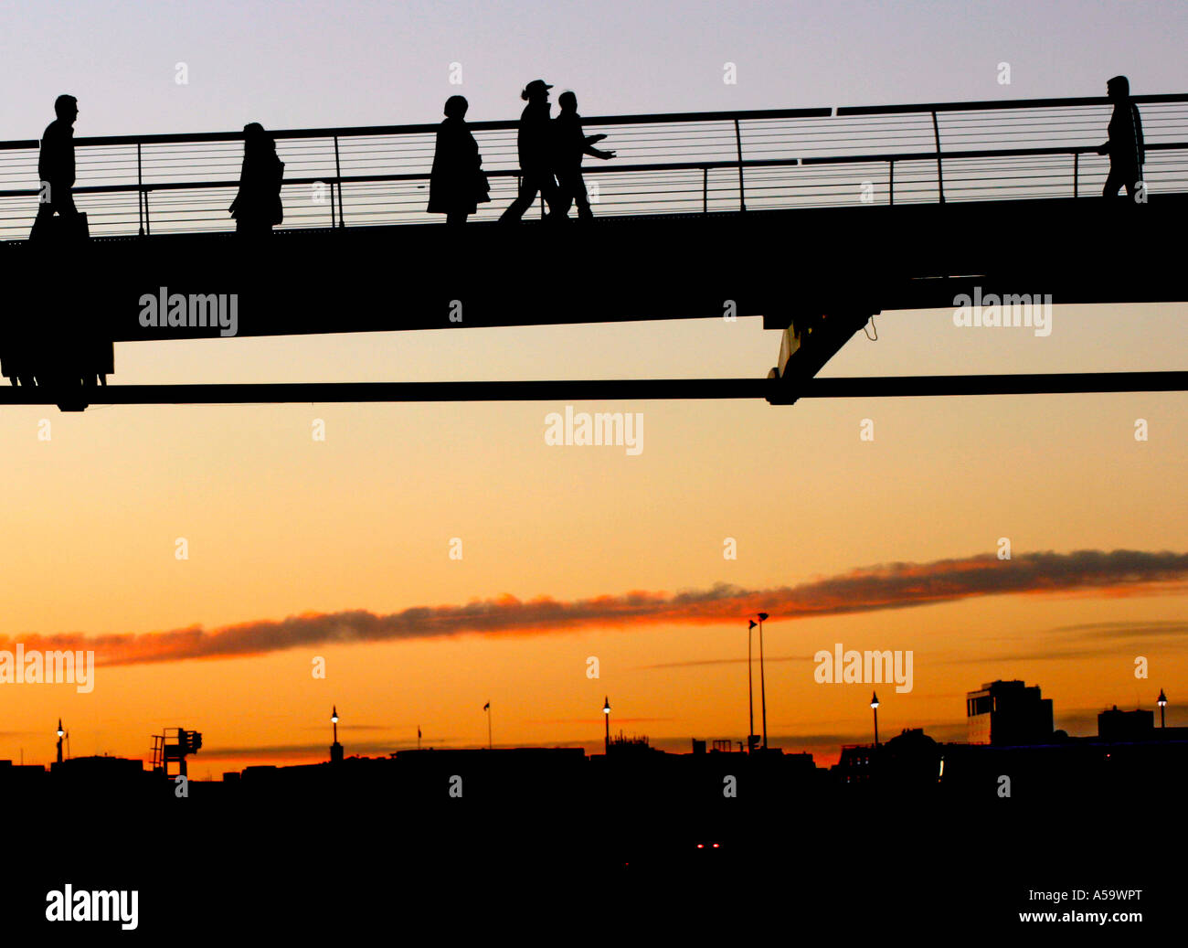 MILLENNIUM SUNSET. People crossing Millennium Bridge at sunset - from ...