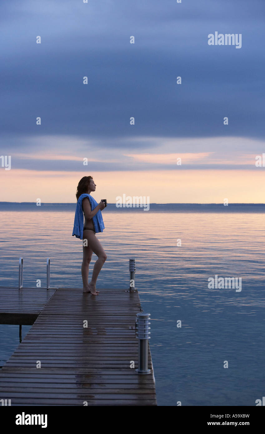Woman on Dock by Water Stock Photo - Alamy