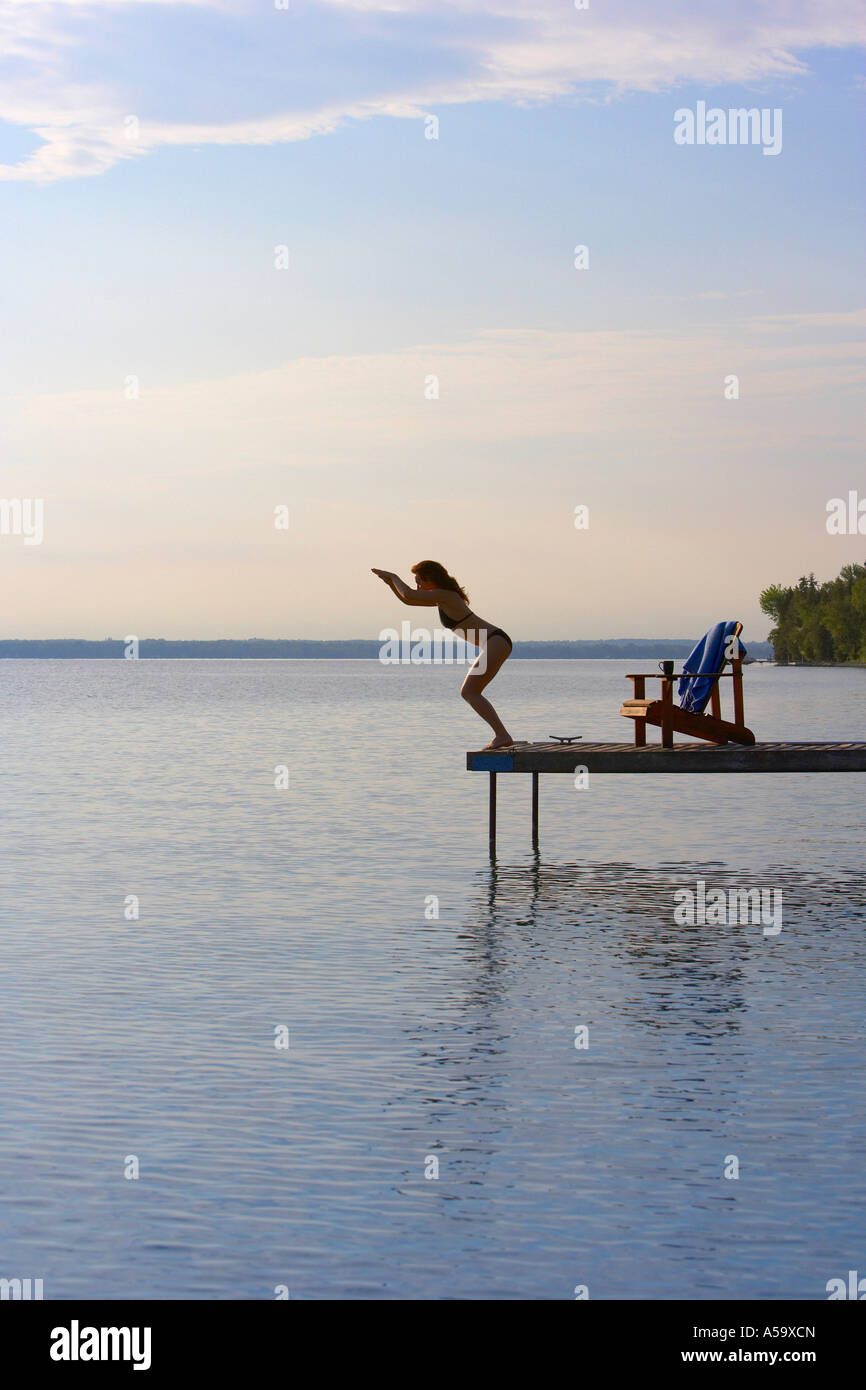 Woman Diving off of Dock Stock Photo - Alamy