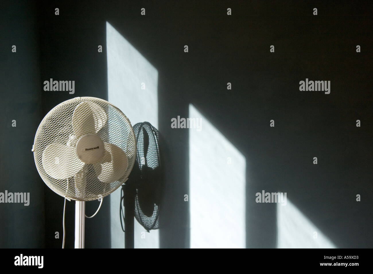 Electric fan and shadow on wall Stock Photo - Alamy