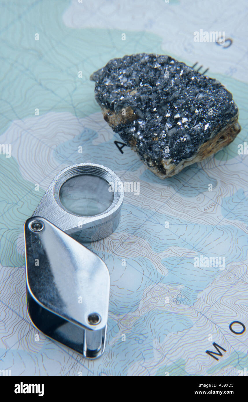 Mining concept mineral magnifier and map Stock Photo - Alamy