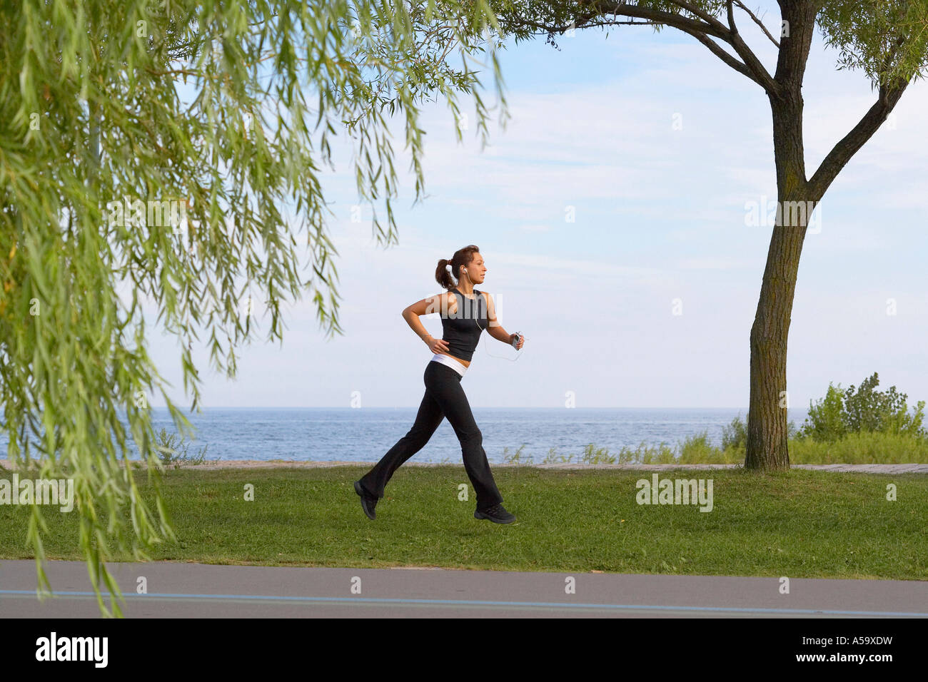 Woman Running in Park Stock Photo - Alamy