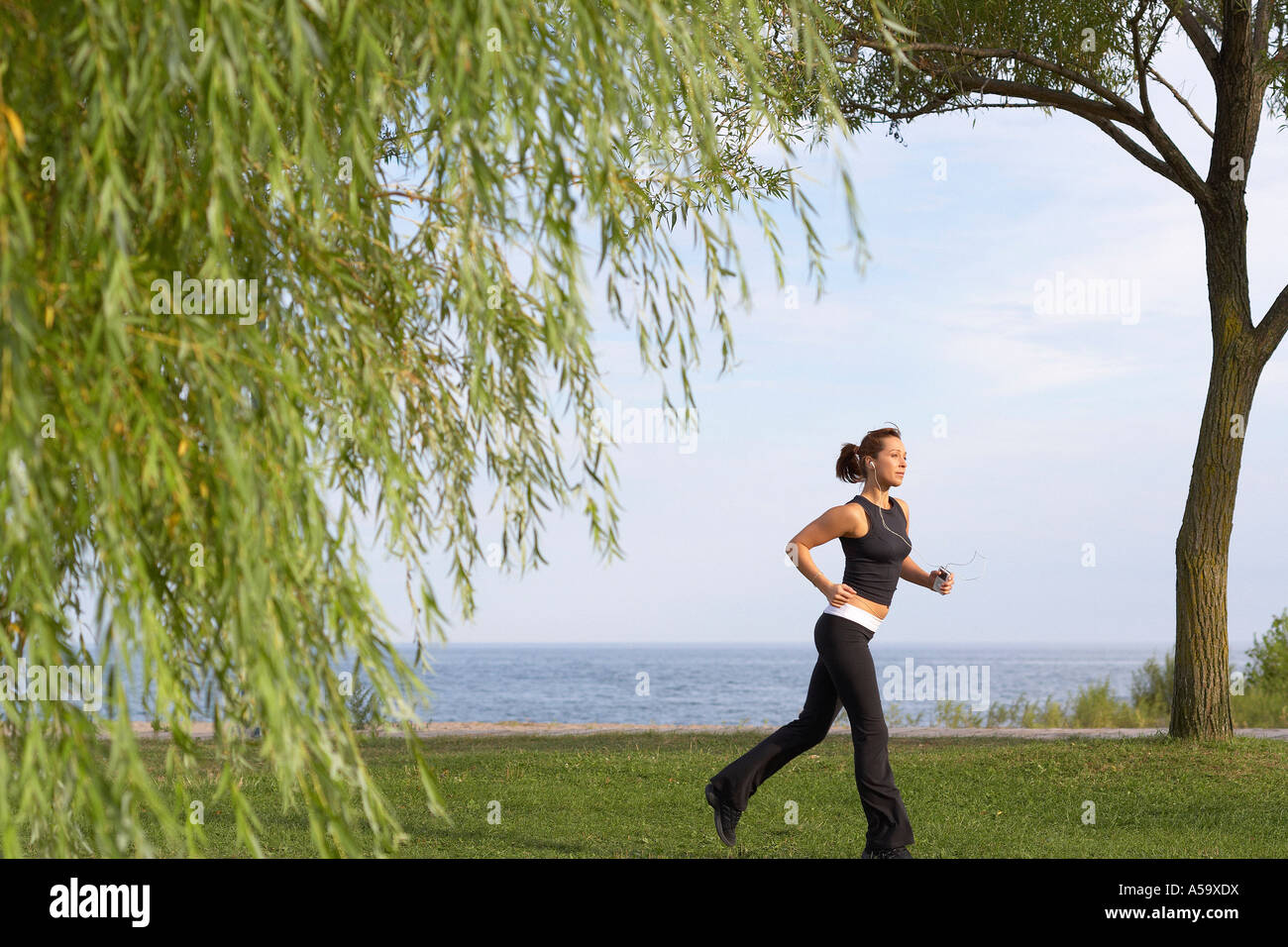 Woman Running in Park Stock Photo - Alamy