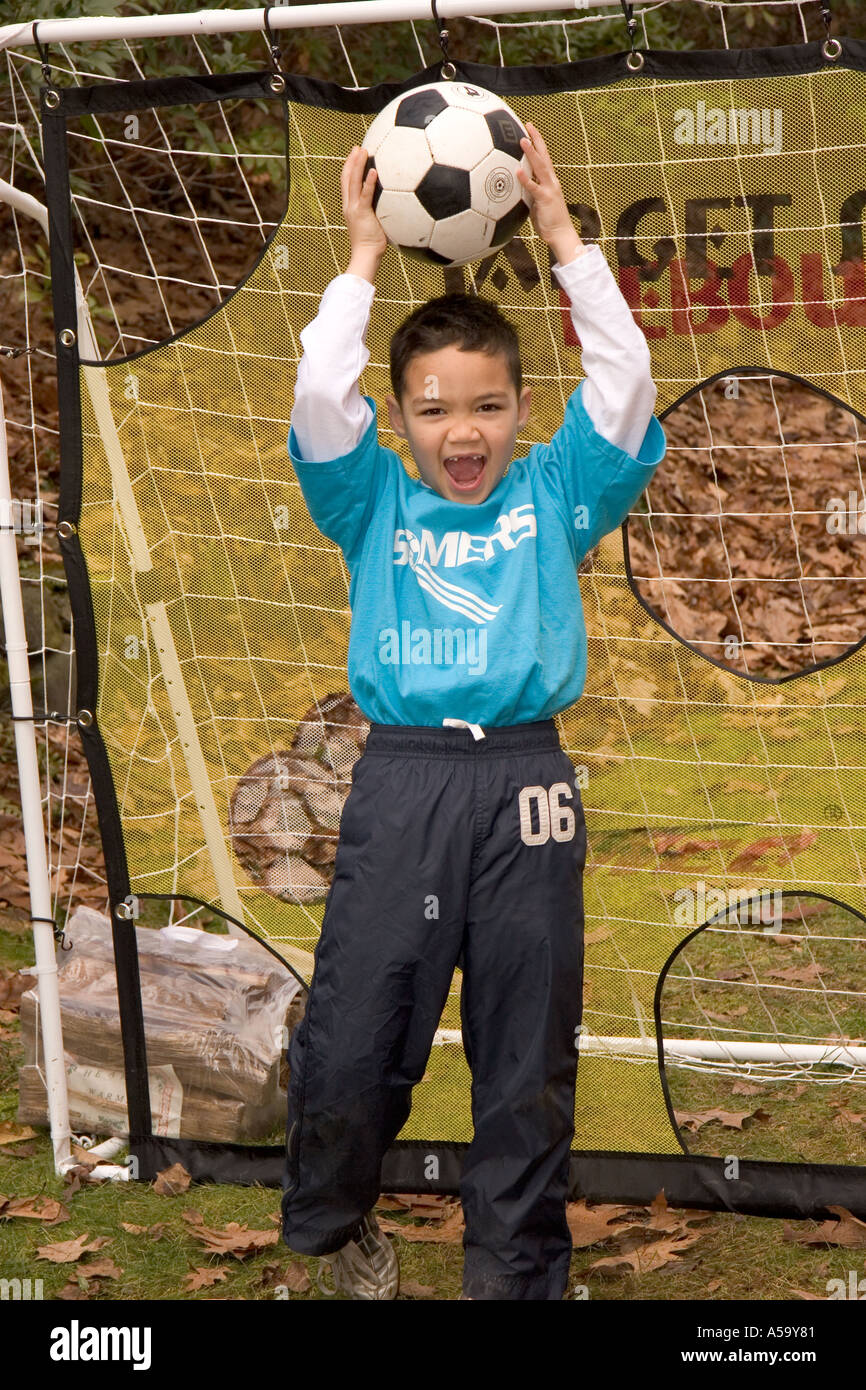Six year old boy with soccer ball and goal Stock Photo - Alamy