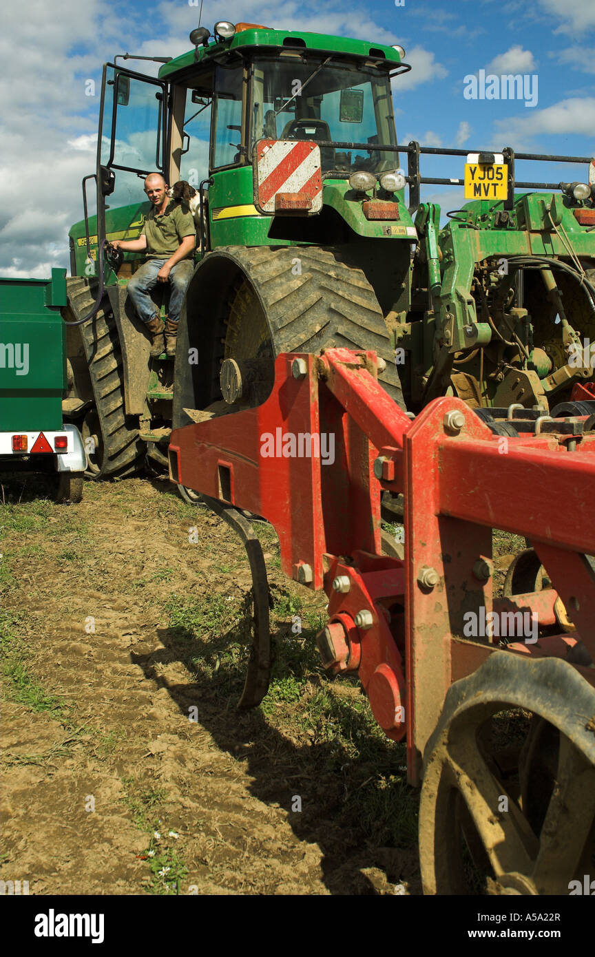 Tractor driver filling up tractor with fuel in the field Stock Photo ...