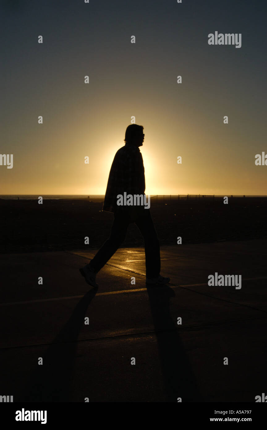 Silhouette of man walking Stock Photo - Alamy