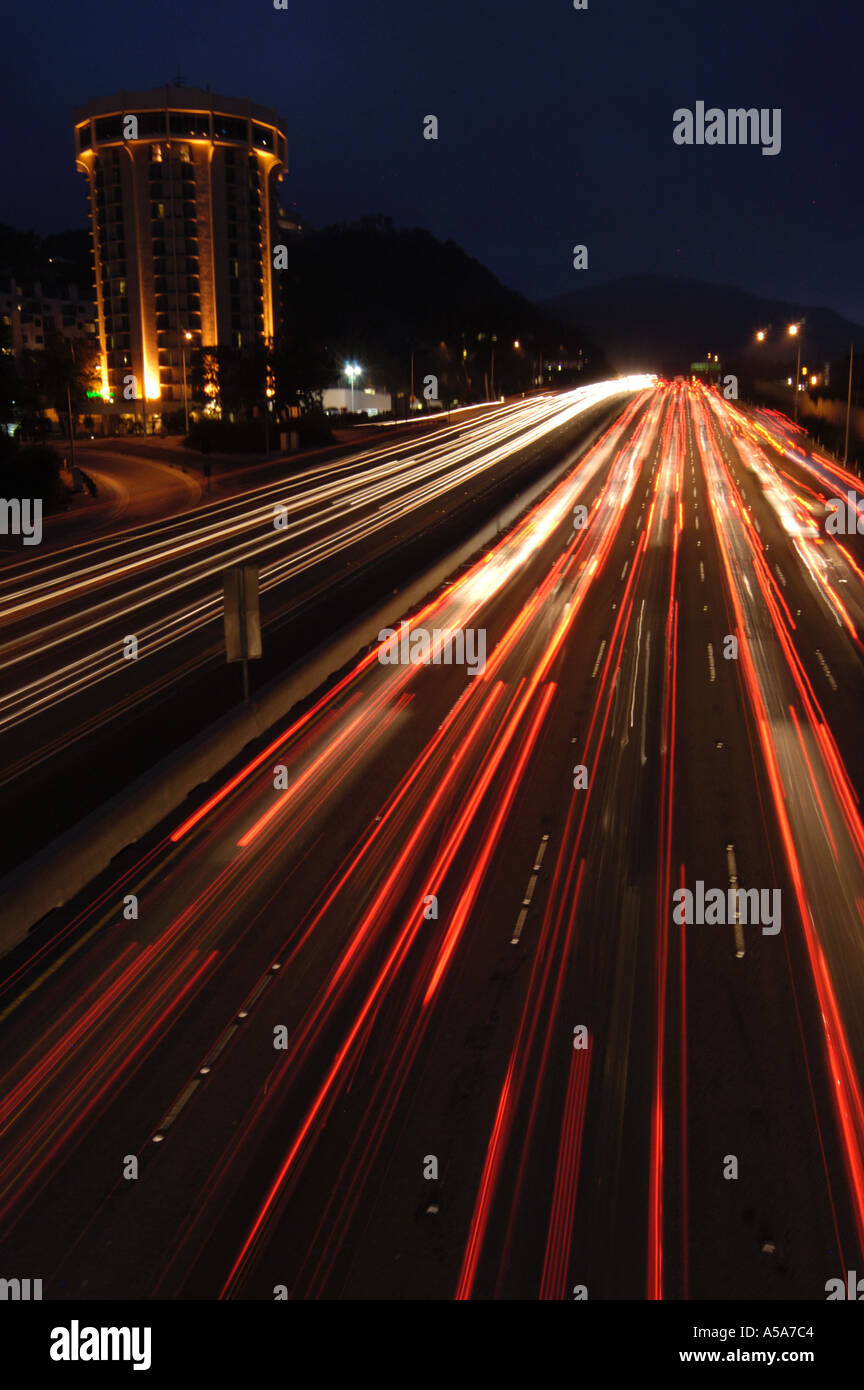 Rush hour night traffic passing Holiday Inn Hotel Beverlyhills ...