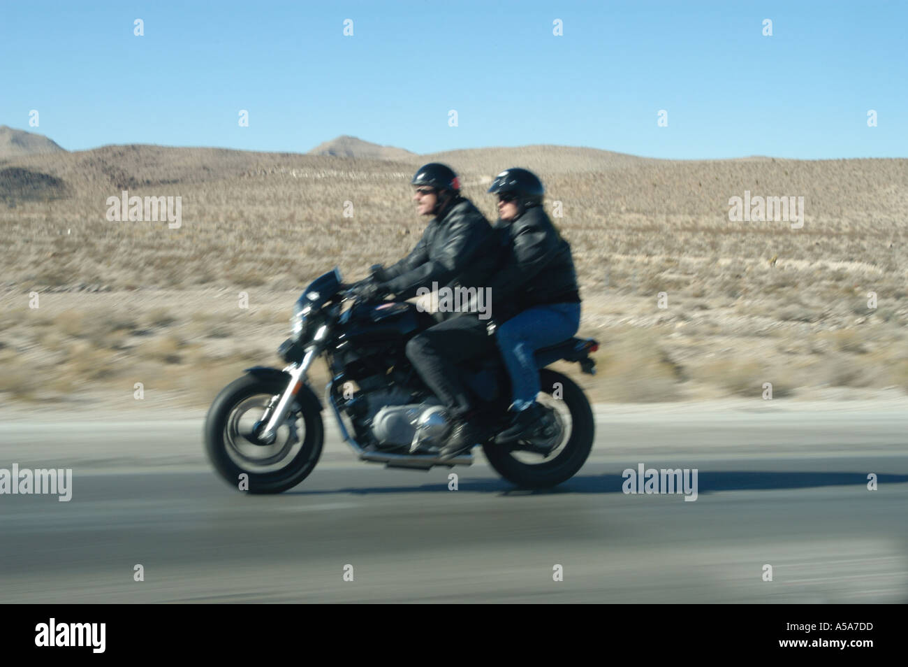 Motorcycle at speed with passenger Stock Photo - Alamy