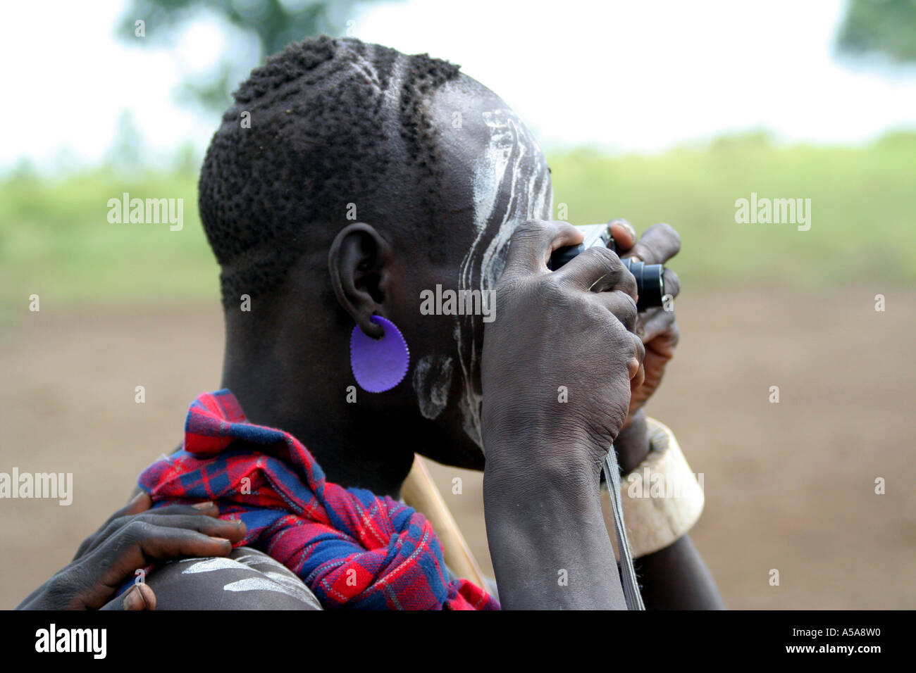 Mursi Tribe man taking a picture with a digital camera, Lower Omo Valle ...