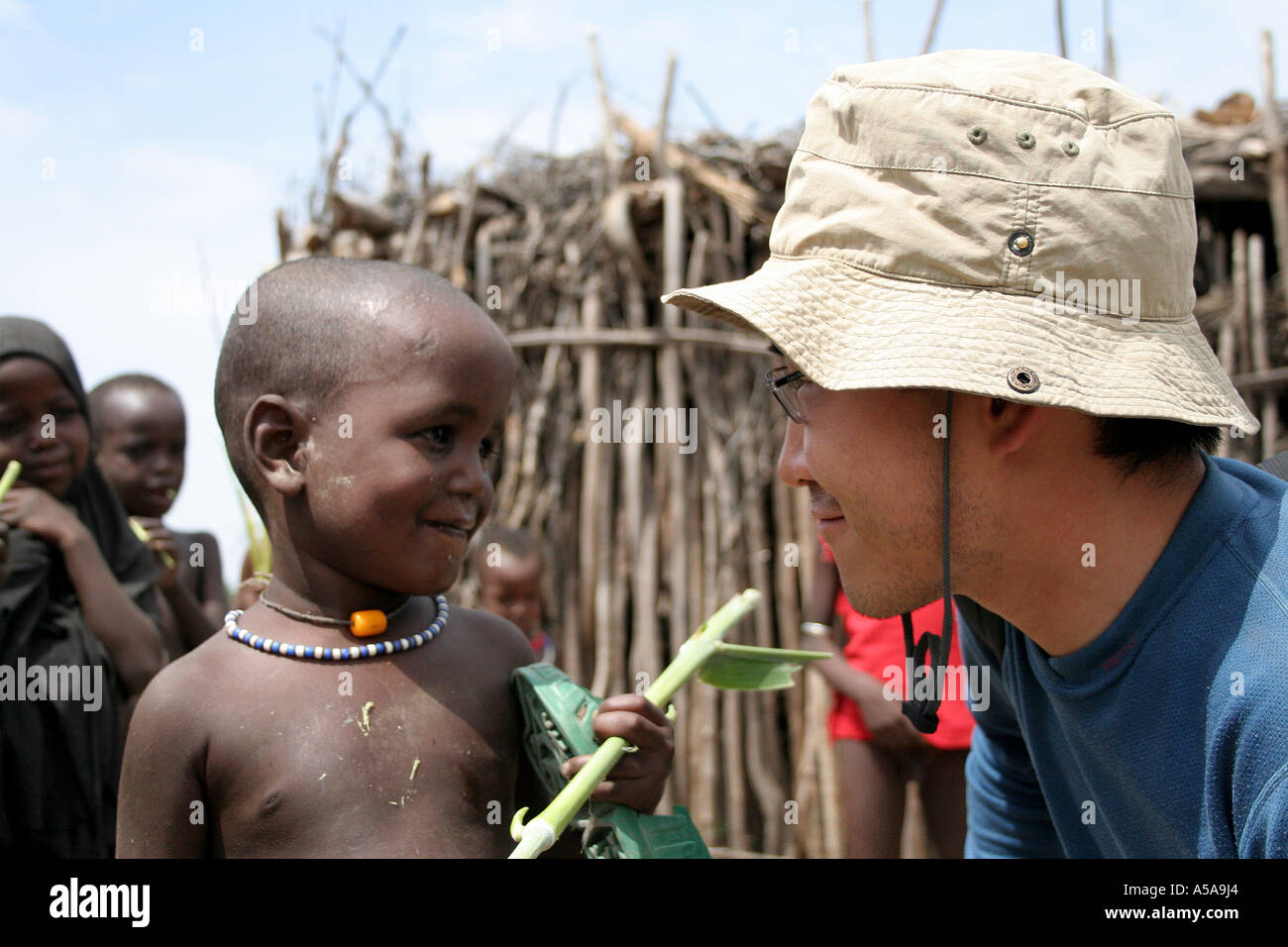 Foreign visitor interacting with Arbore child, Lower Omo Valle ...