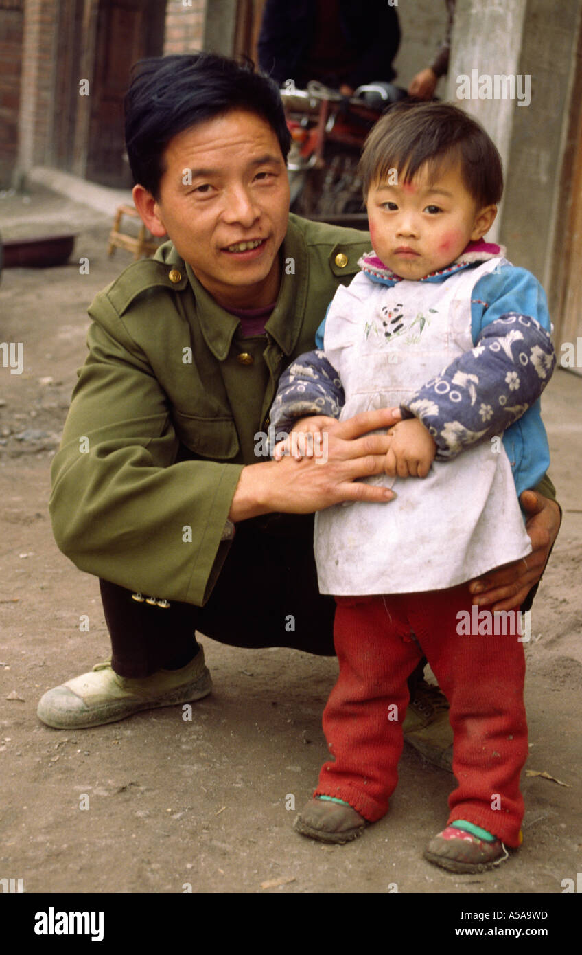 Man and grubby child- village in Sichuan China Stock Photo - Alamy