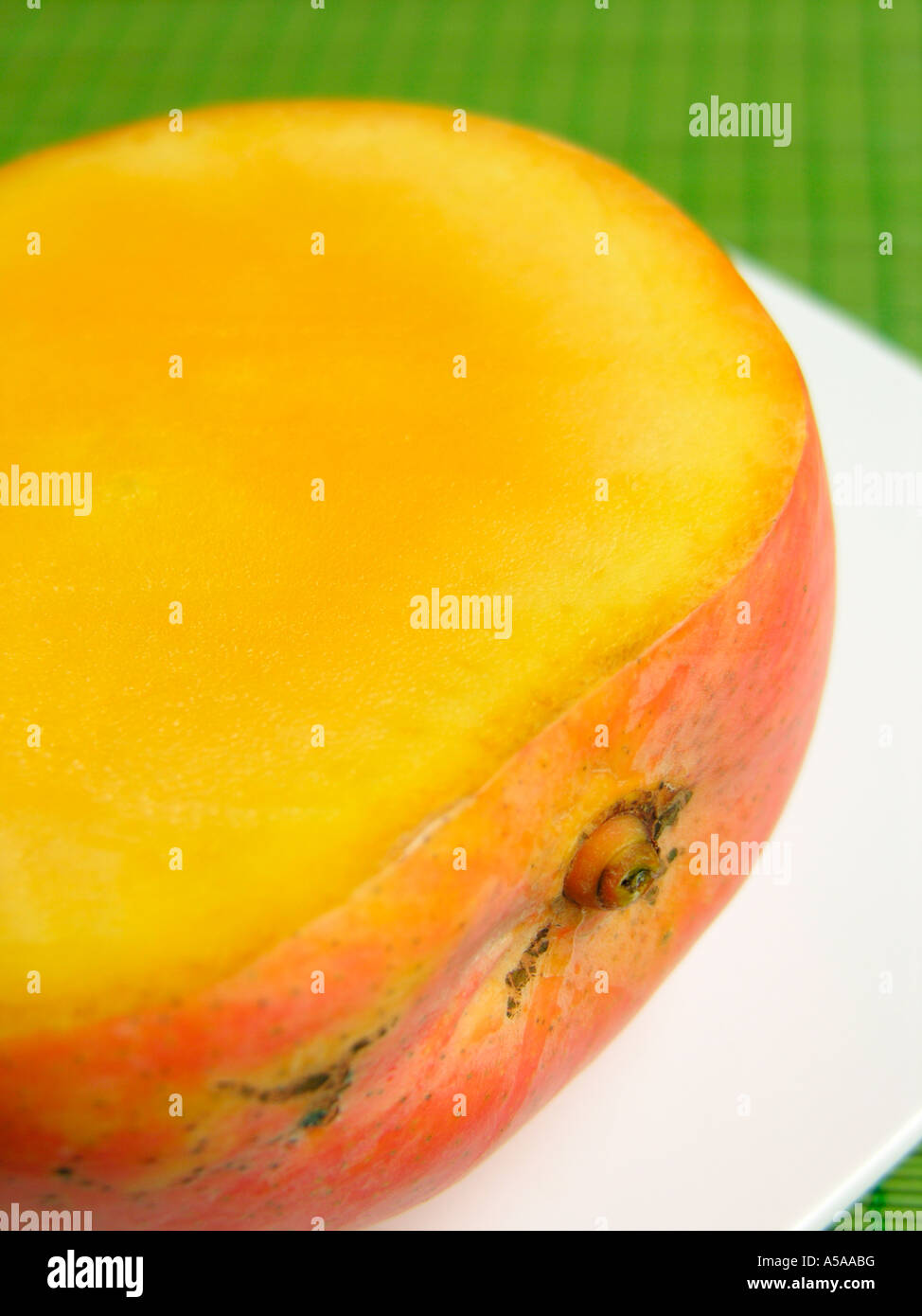 Big mango cut open on white plate Stock Photo - Alamy