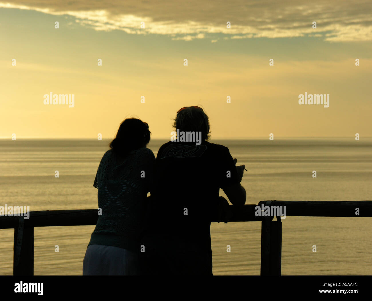 Romantic couple looking distance sunset hi-res stock photography and ...
