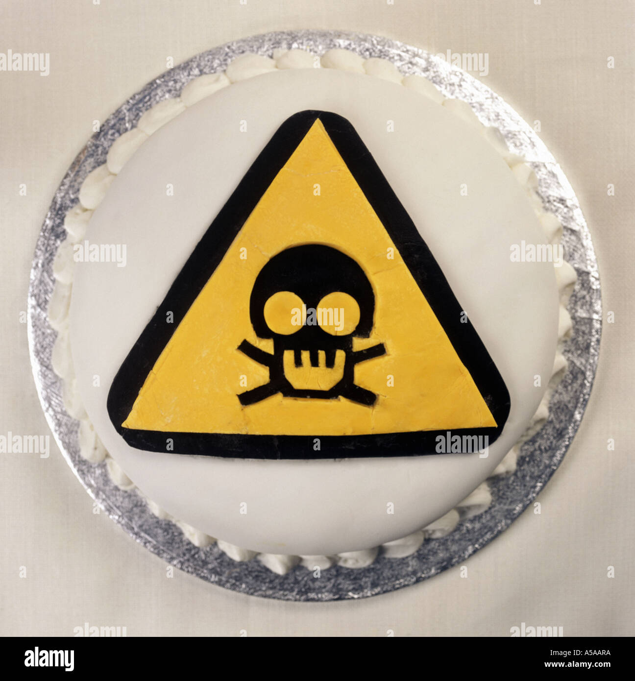 a cake with a poison sign made from icing Stock Photo - Alamy