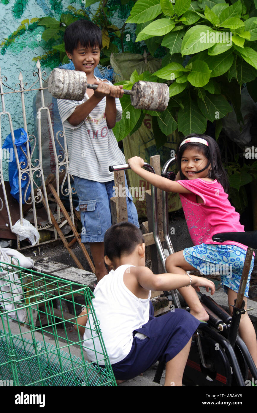 Manila, Philippine Islands, children lifting homemade concrete weights ...