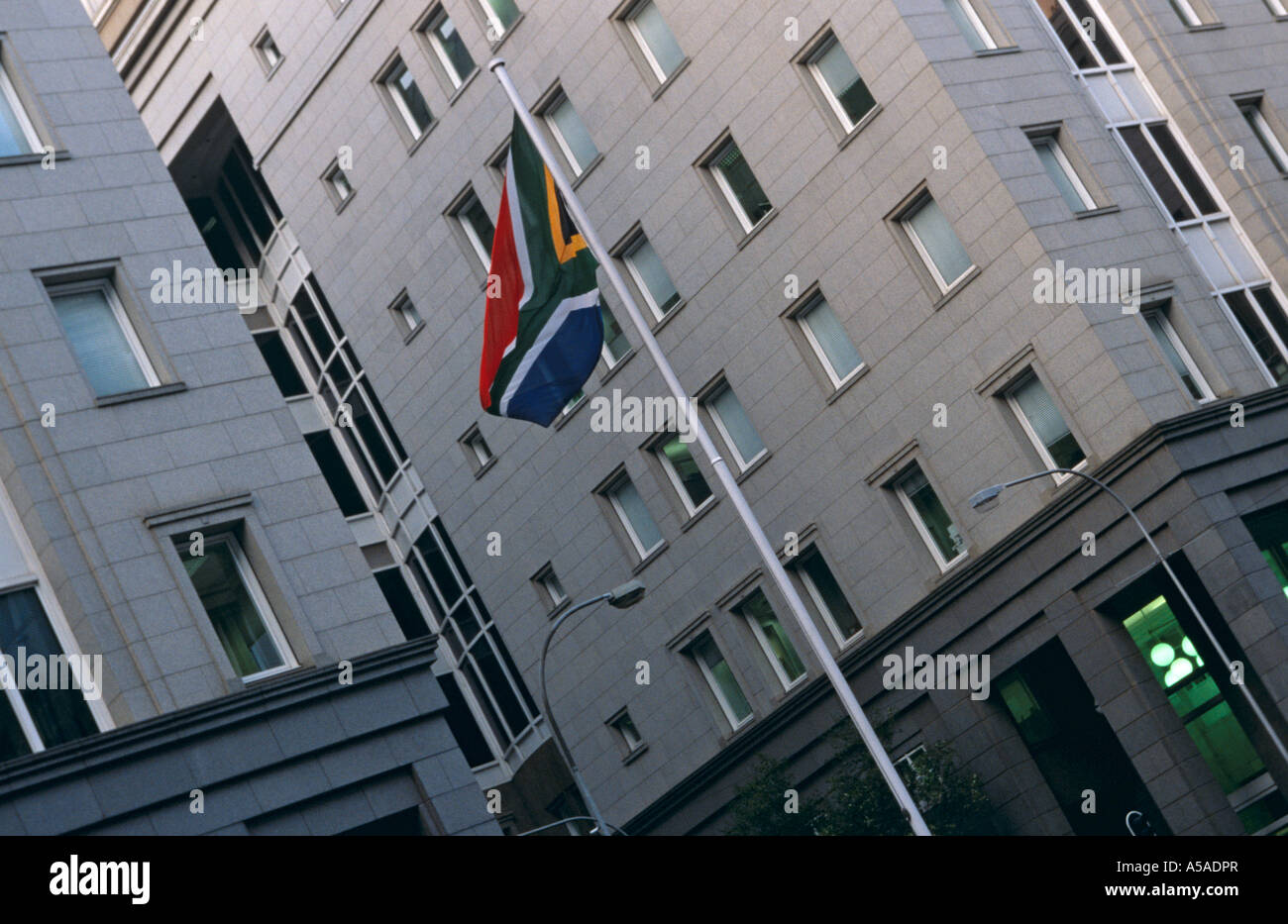 The flag of South Africa against a modern building in Johannesburg ...
