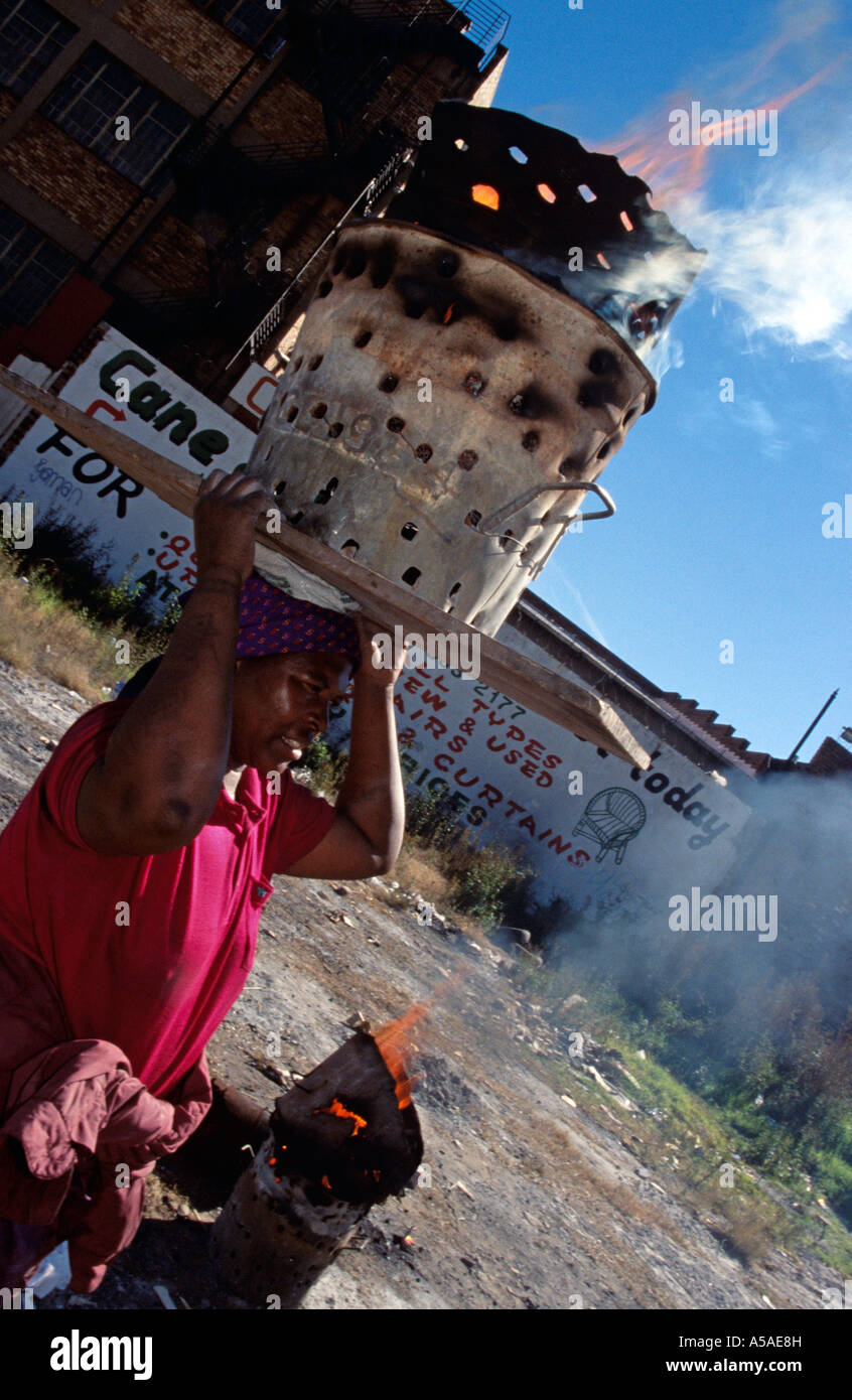 A South African woman carrying a hot barrel on her head Stock Photo - Alamy