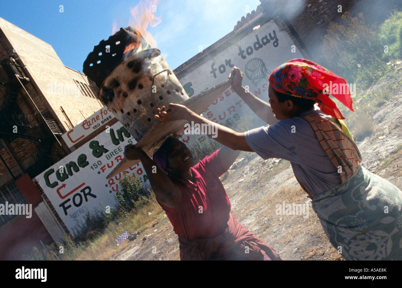 Two South African women carrying a hot barrel Stock Photo - Alamy