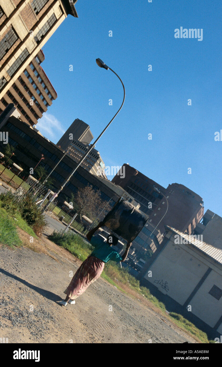 A South African woman carrying a barrel on her head Stock Photo - Alamy