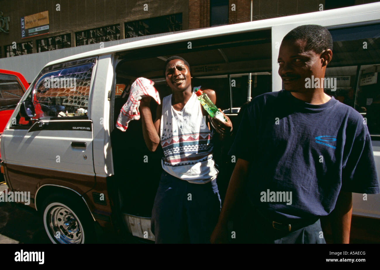 Men getting off a van in Johannesburg South Africa Stock Photo - Alamy