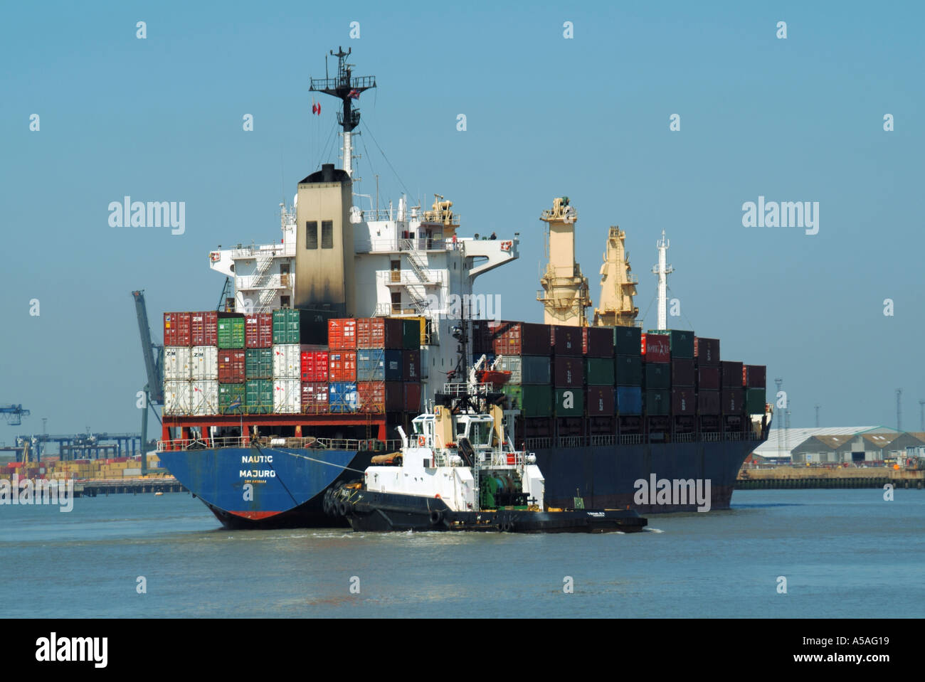 Arriving cargo container freighter ship stacked with load of shipping ...