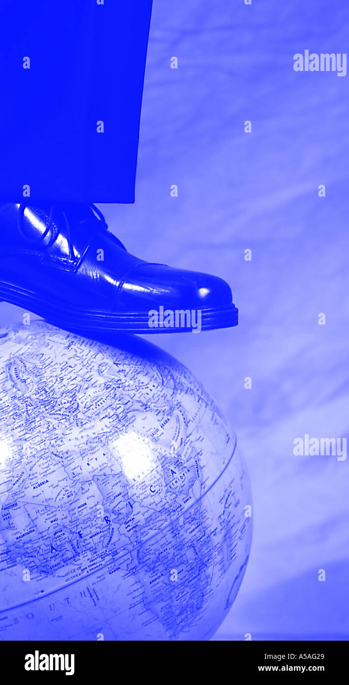 Foot on globe in blue tint Stock Photo - Alamy