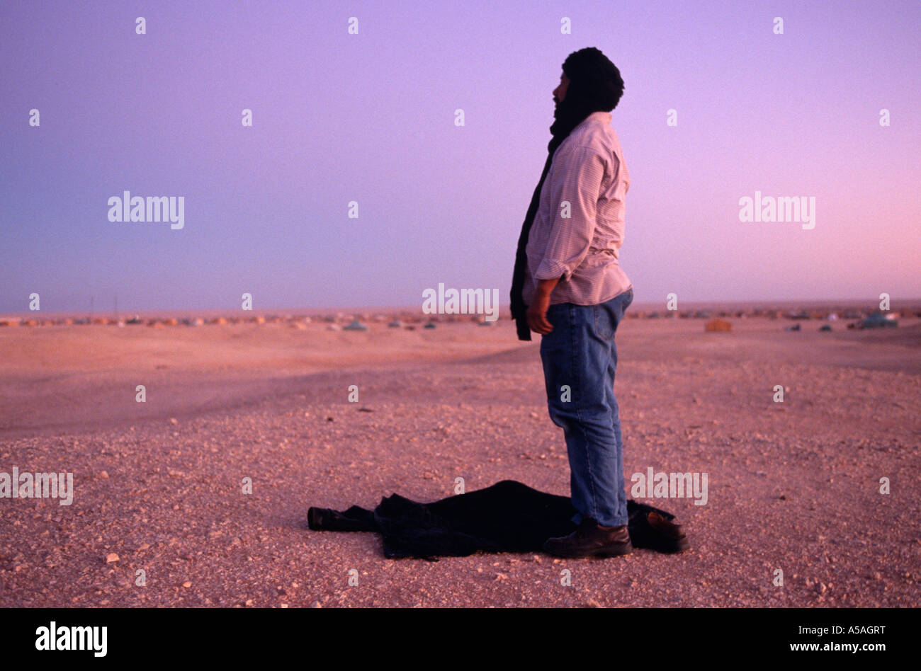 A muslim man performing his daily ritual prayers at the refugee camp in ...