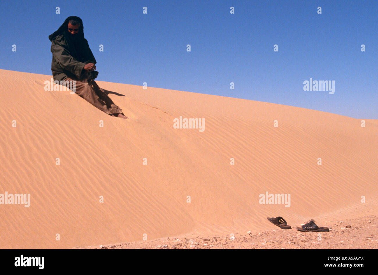 Sahrawi man sitting on sand, Tindouf, Western Algeria Stock Photo - Alamy
