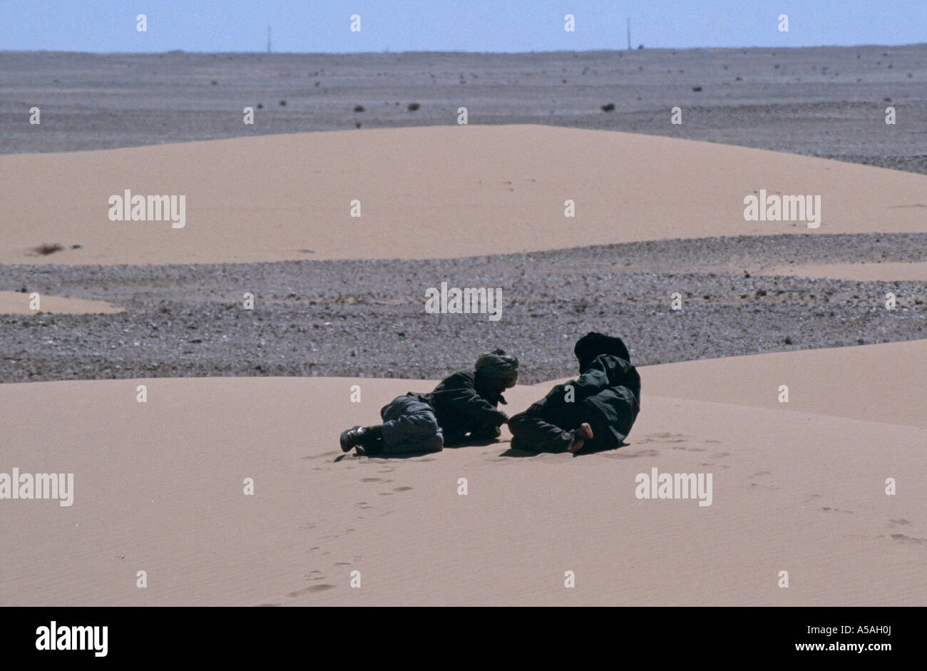 Sahrawi men lying down on the sand in Tindouf Western Algeria Stock ...