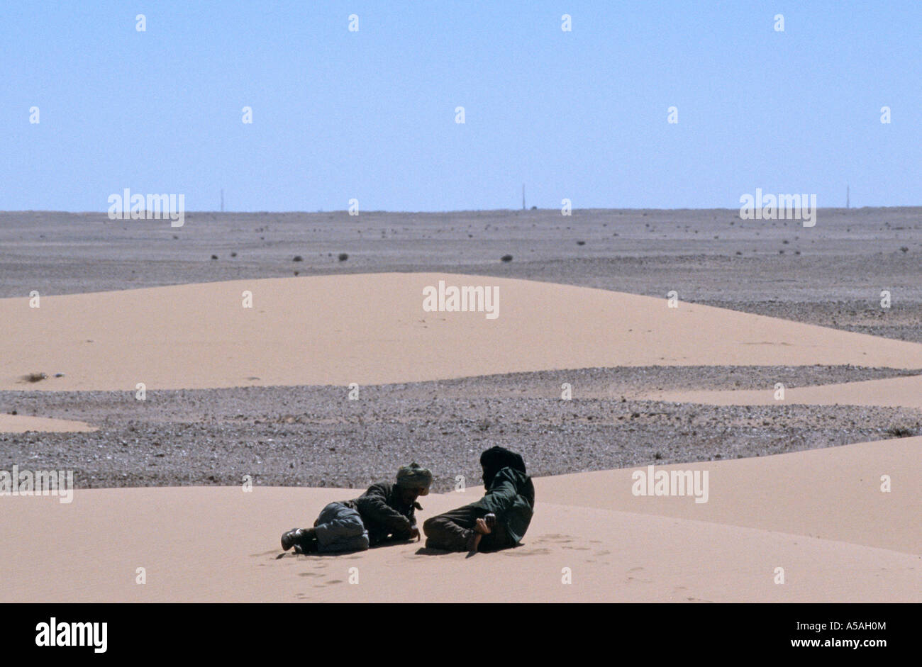 Sahrawi men lying down on the sand in Tindouf Western Algeria Stock ...