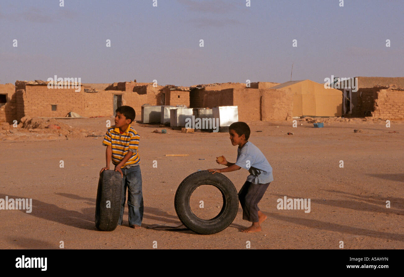 Sahrawi children playing with rubber tyres in Western Algeria Stock ...