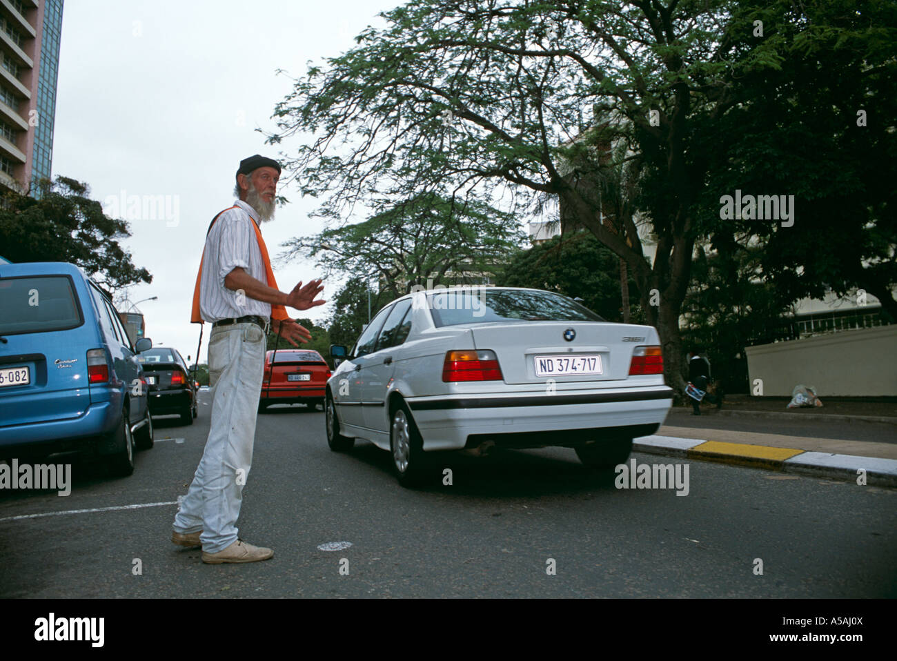 A security guard guiding the cars on a road in Durban South Africa ...