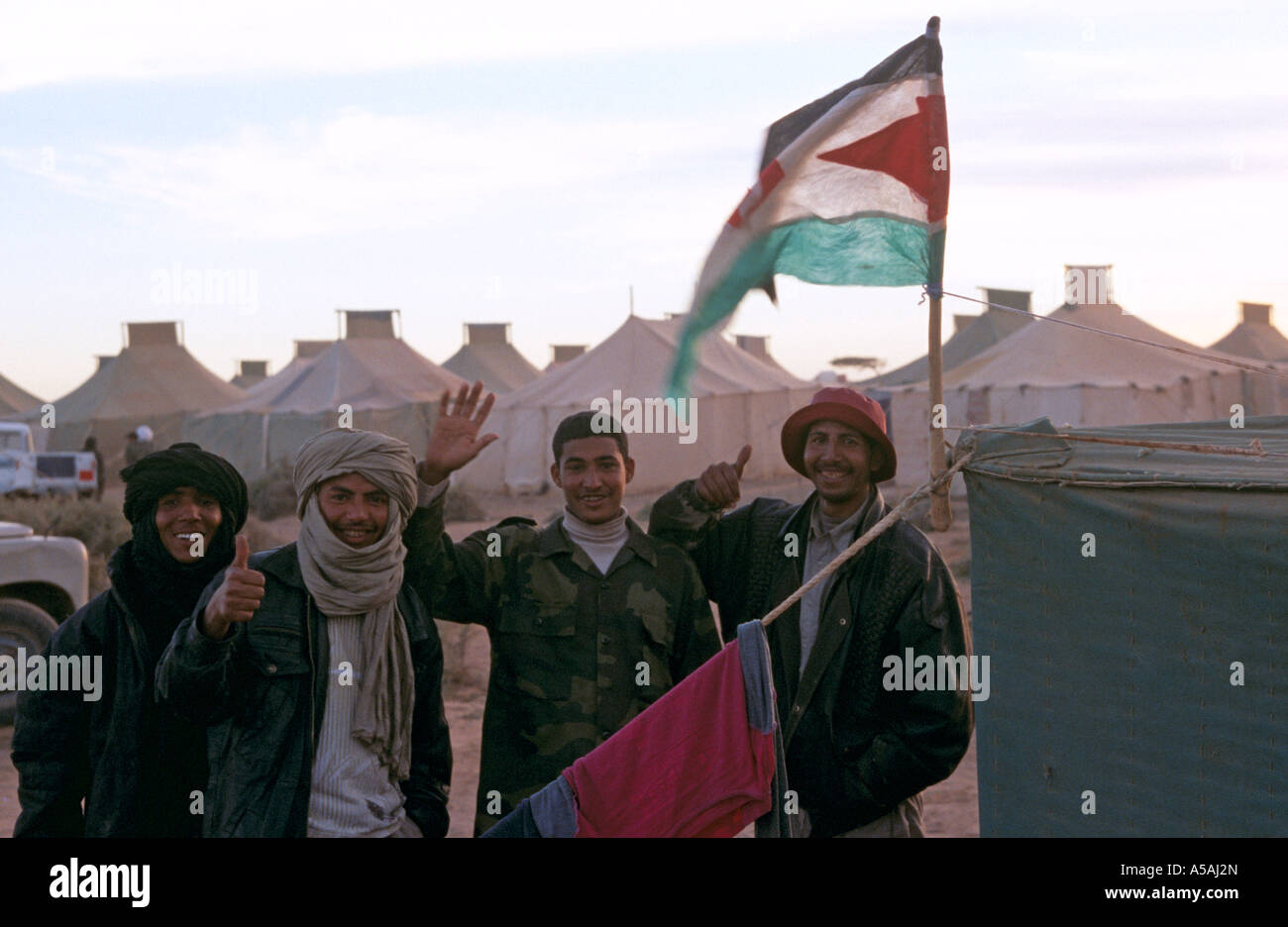 Sahrawi refugees holding the Western Sahara flag Stock Photo - Alamy