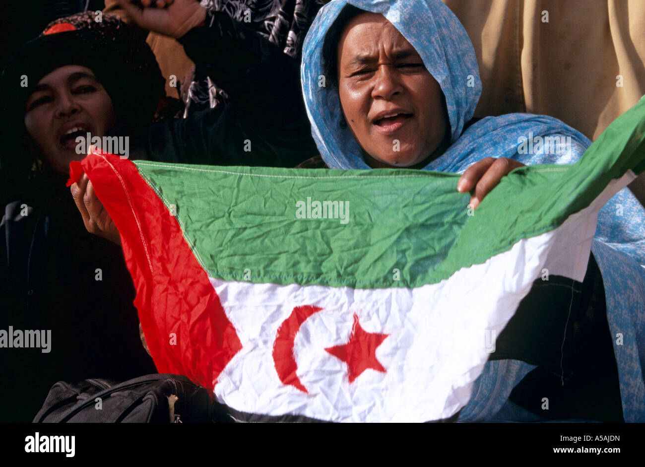 A woman holding the Western Sahara flag during the Sahrawi Independence ...