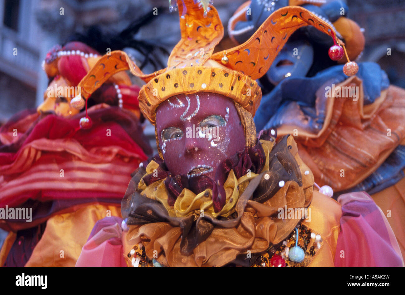 People dressed in fancy costumes celebrate the Venetian Carnival in ...