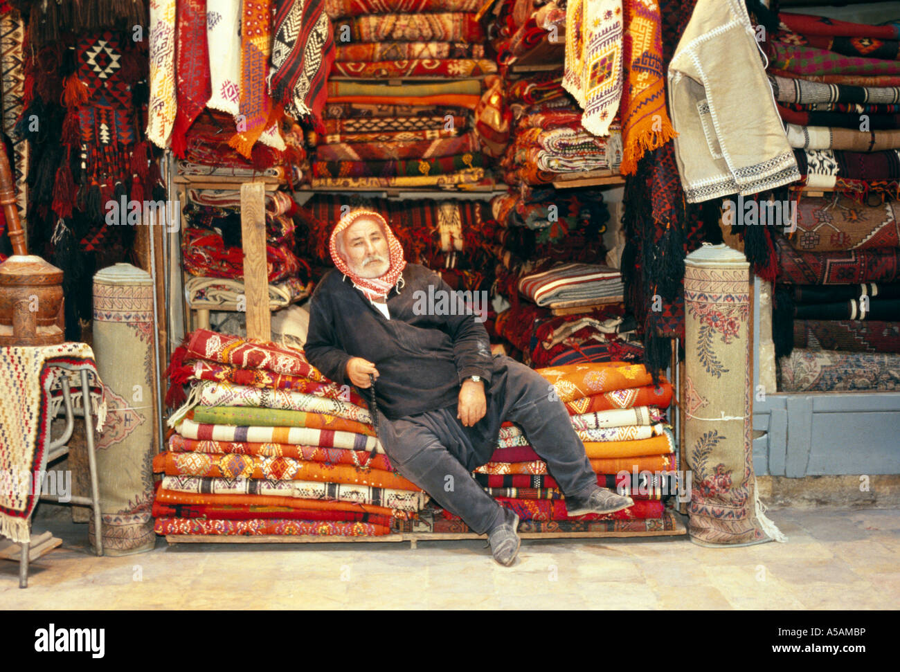 A man selling carpets takes a nap in his shop in Aleppo Souq Syria ...