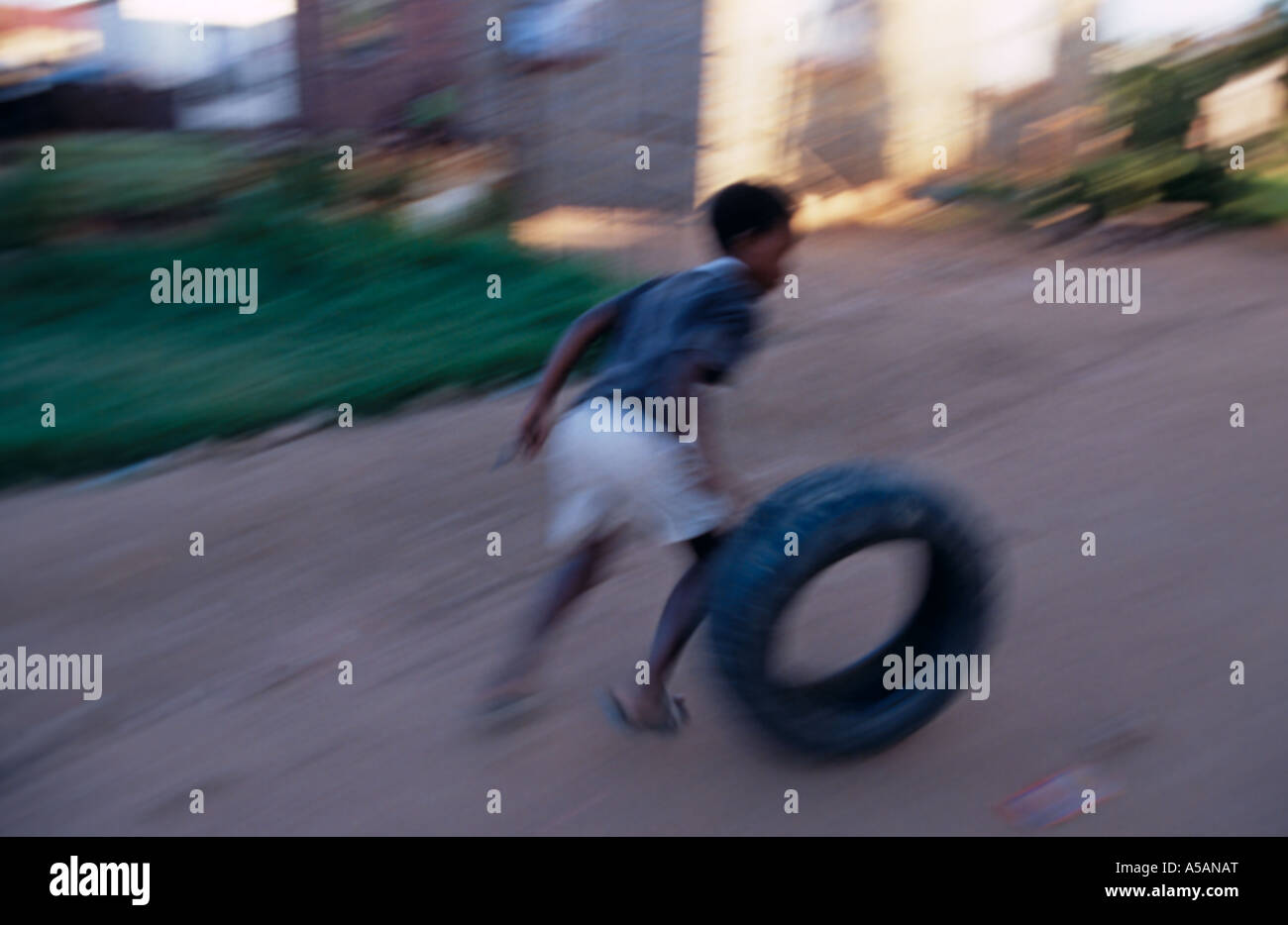 A boy rolling a tyre on the road in Malawi Africa Stock Photo - Alamy