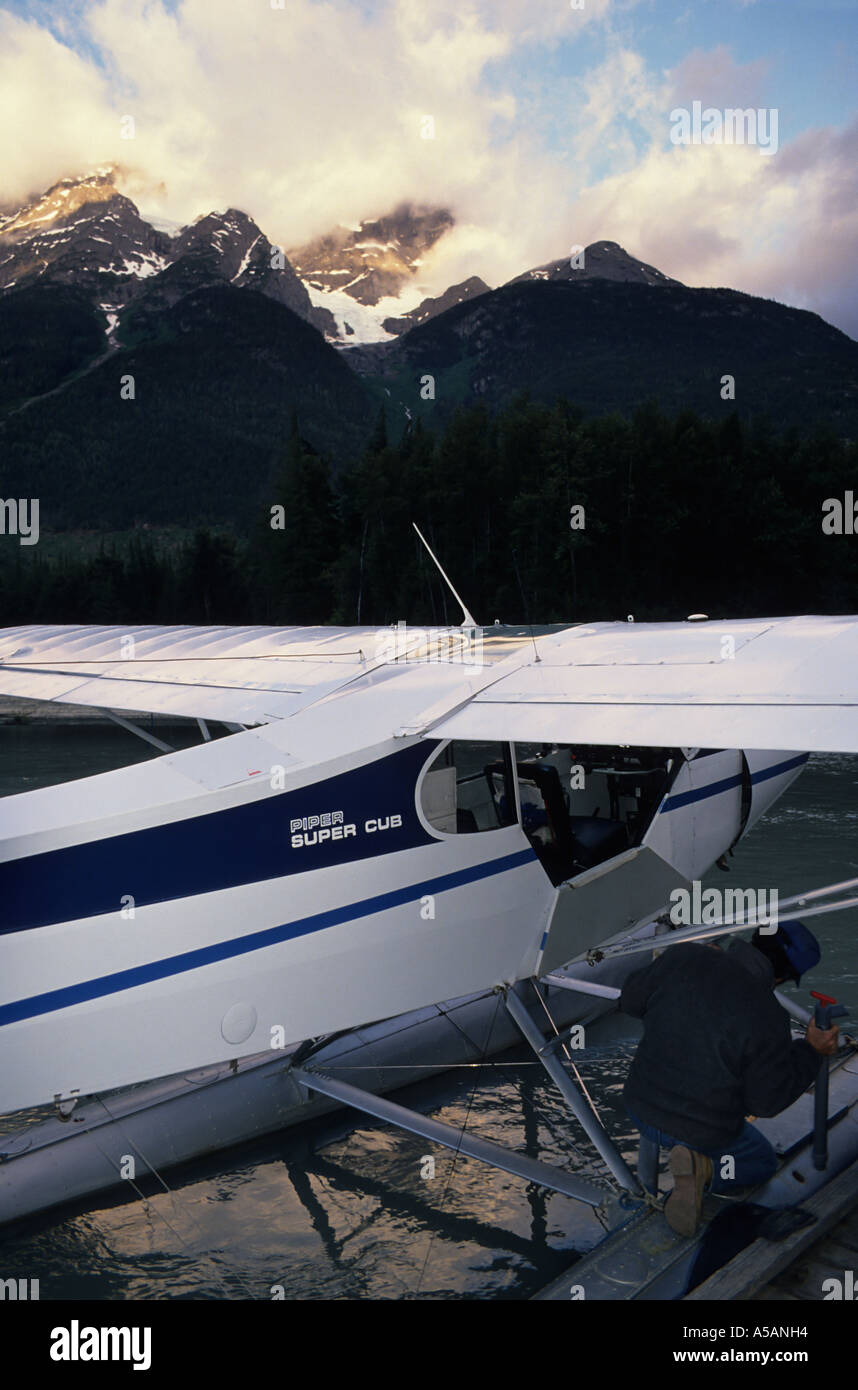 Super Cub floatplane pilot readying for take off Bella Coola river ...
