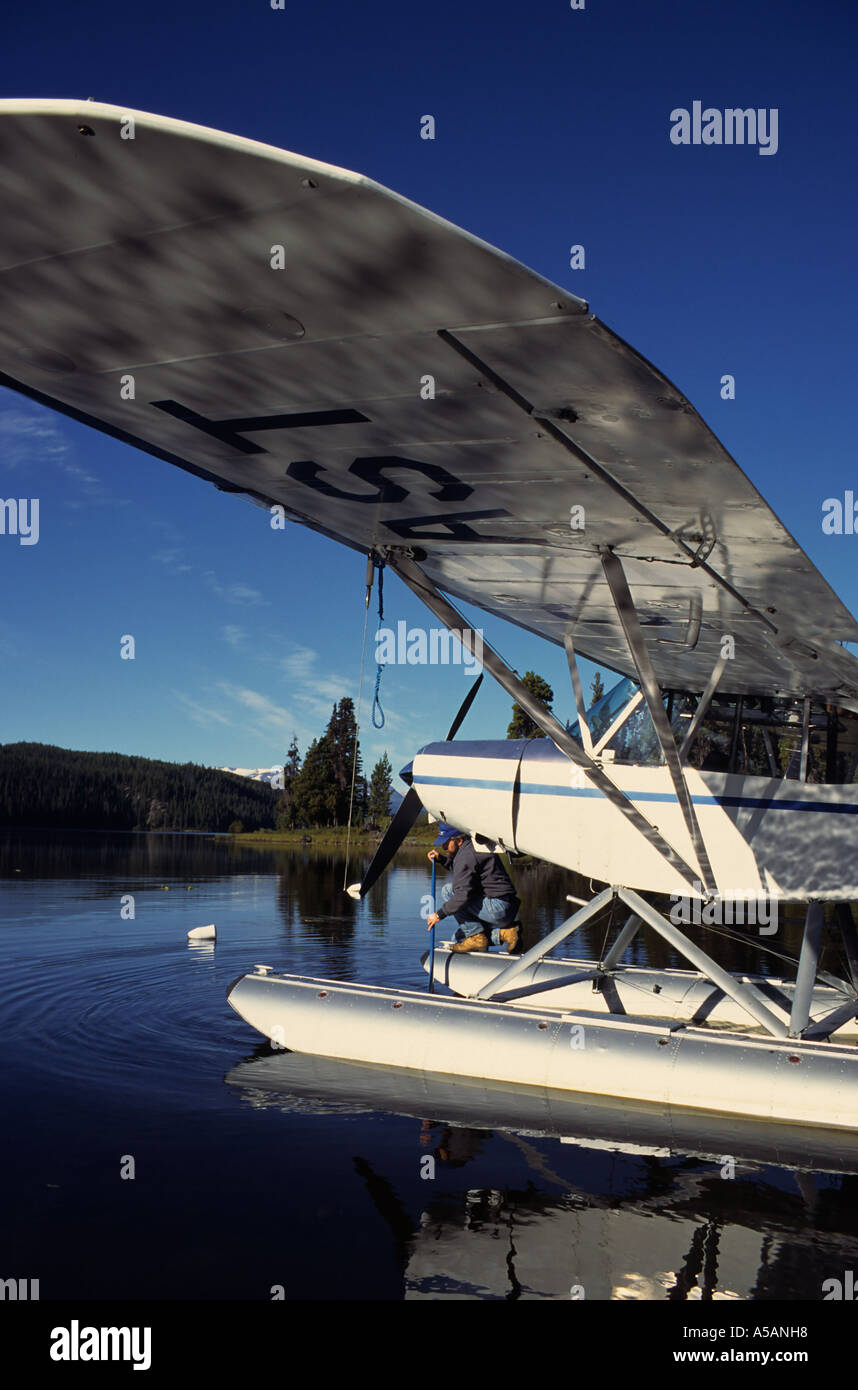 Super Cub floatplane pilot paddling out for take off Nadina lake ...