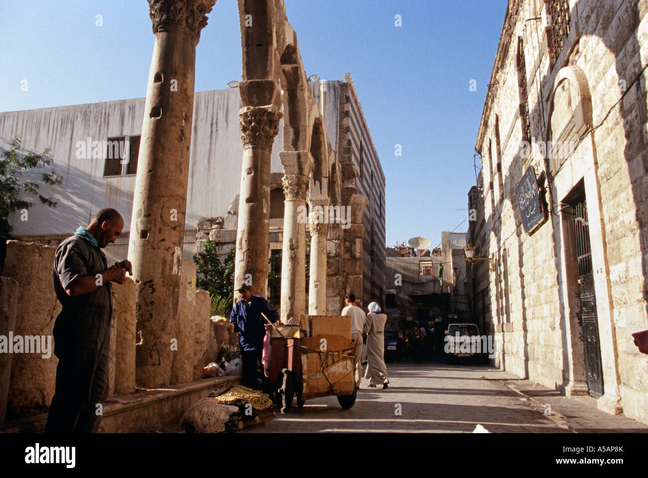 A man collecting garbage outside the Umayyad mosque in Damascus Syria ...