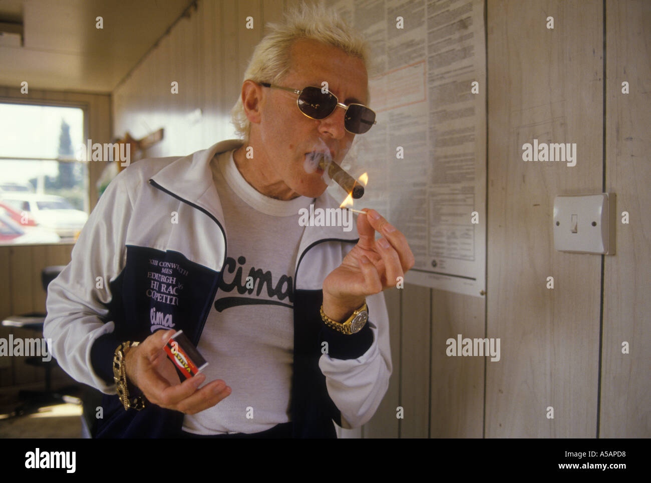 Jimmy Saville TV personality with lighting up his trademark cigar ...