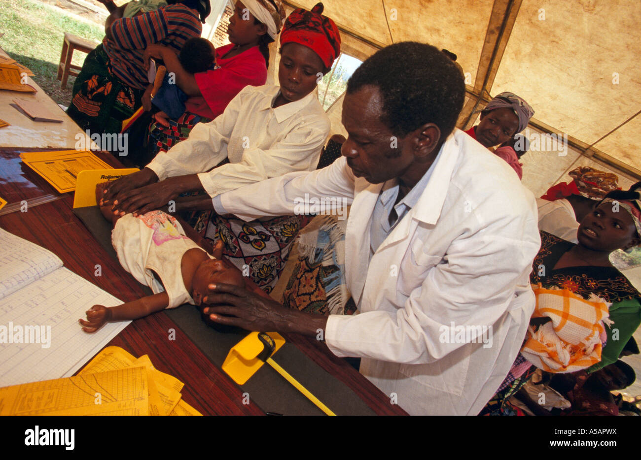 Doctor treating patients at health clinic, Kampala, Uganda Stock Photo ...