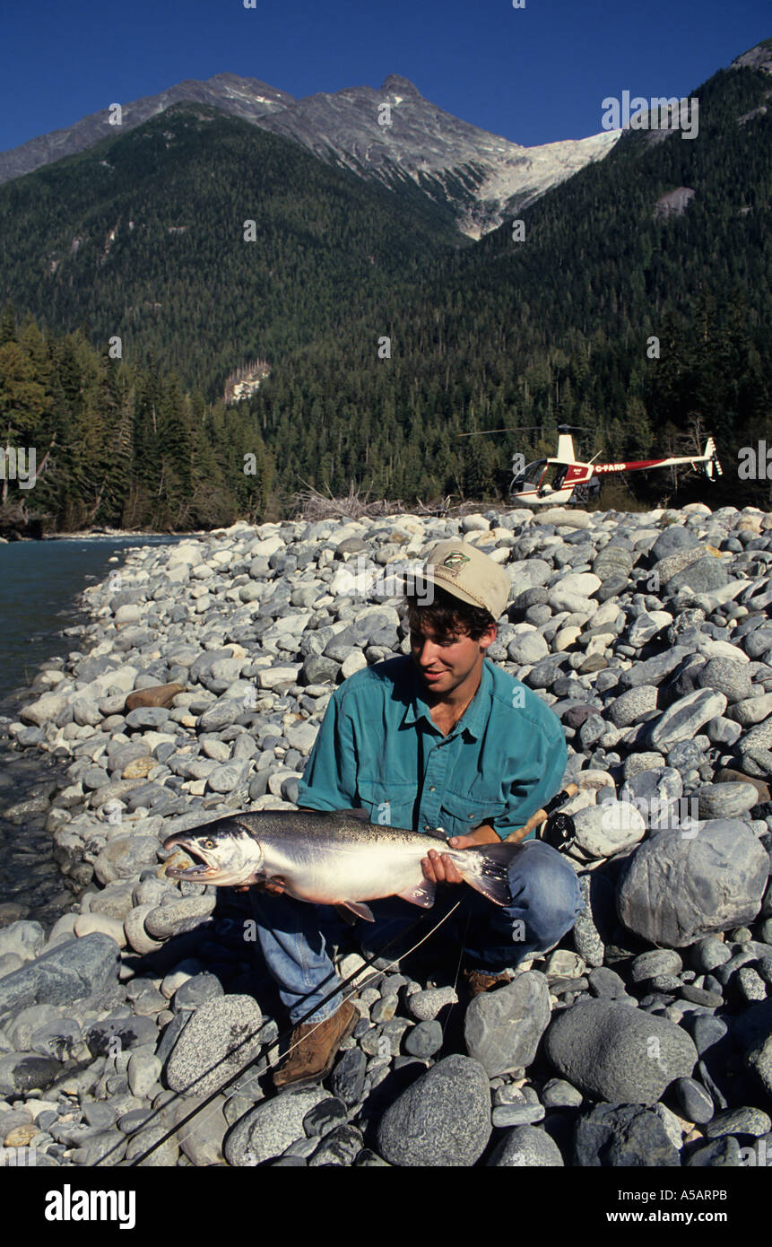 Helicopter flyfisherman holding coho salmon Kitlope Heritage ...