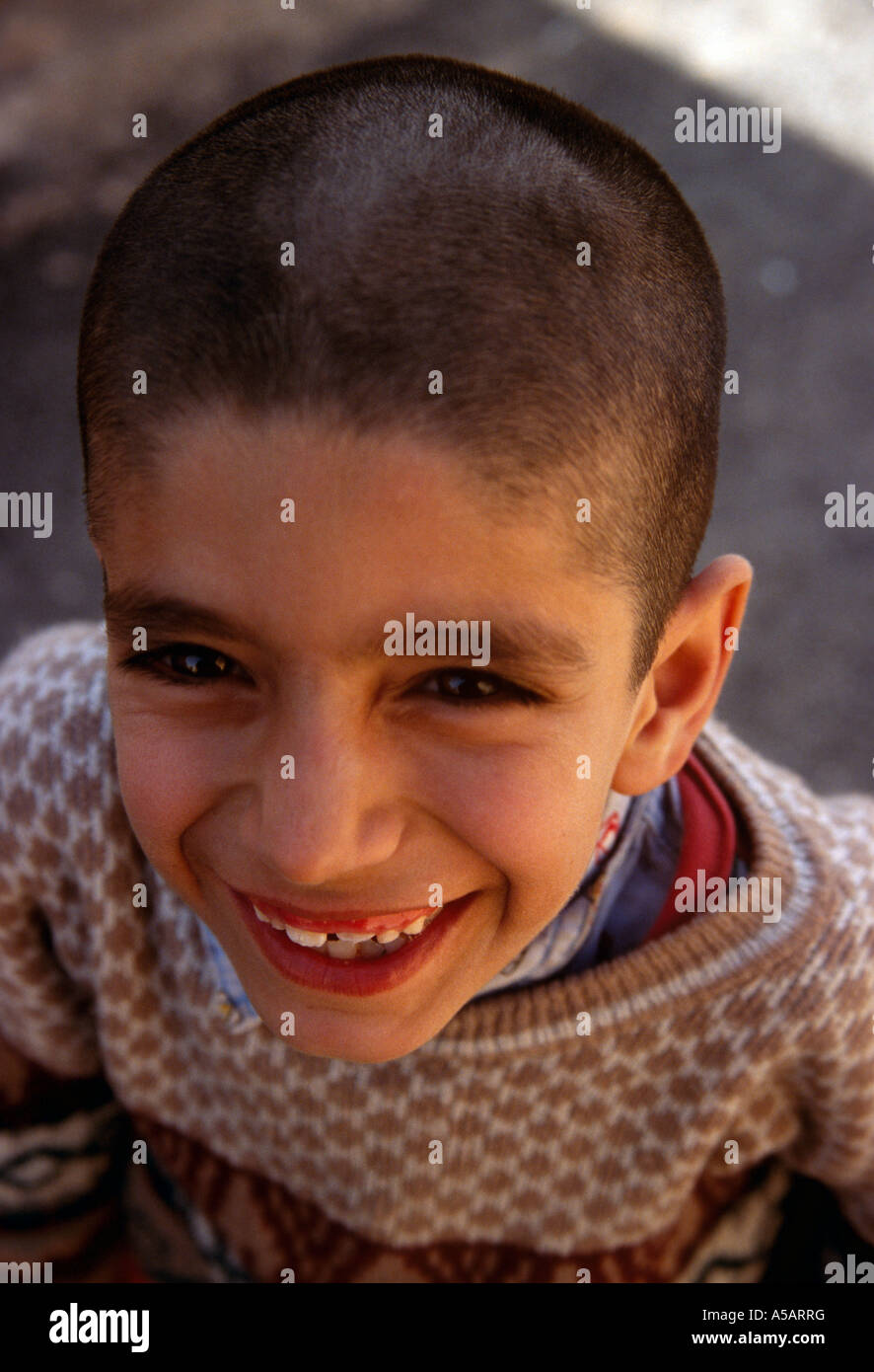 Portrait of a young boy smiling in Teheran Iran Stock Photo - Alamy