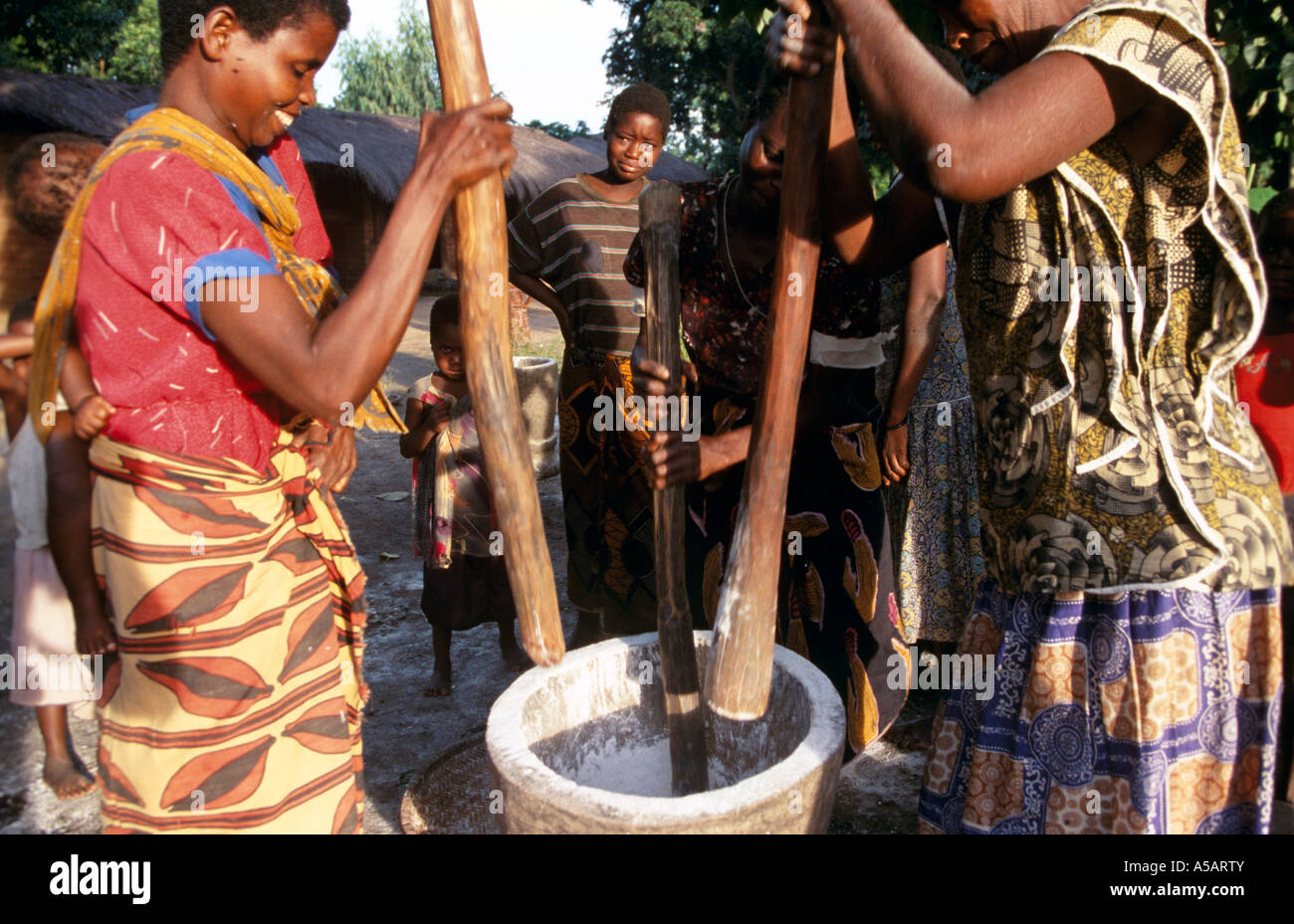 Women grinding in Uganda Africa Stock Photo - Alamy
