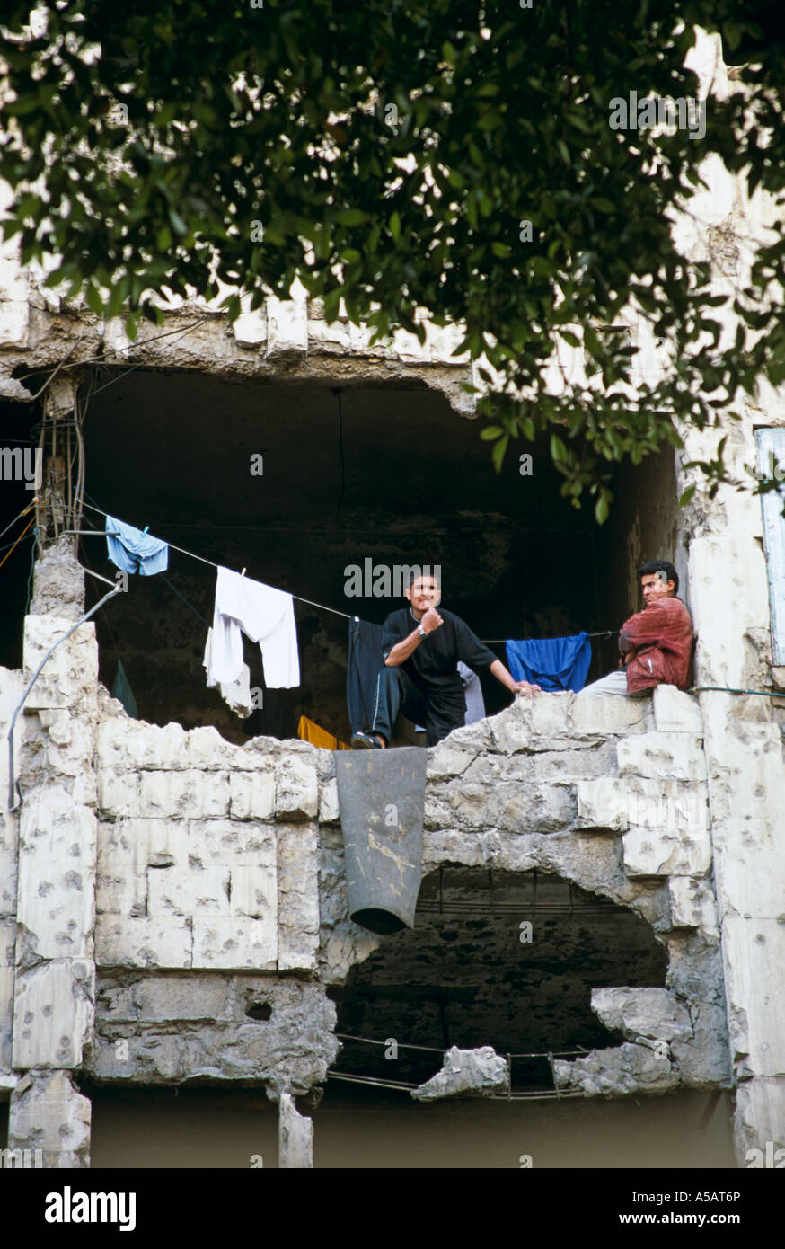 Men sitting on a damaged building Beirut Stock Photo - Alamy