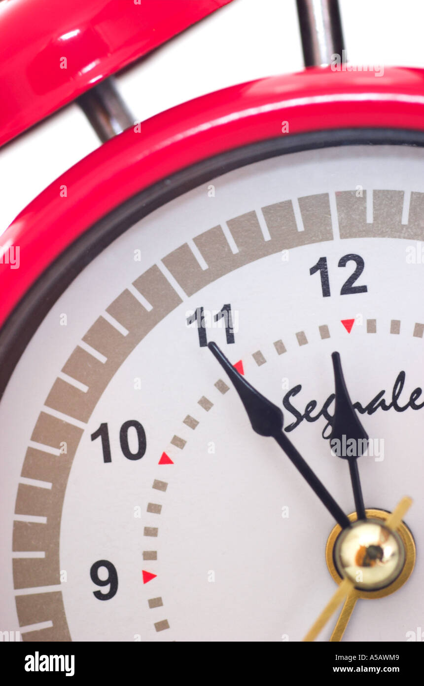 Alarm clock showing five to twelve Stock Photo - Alamy