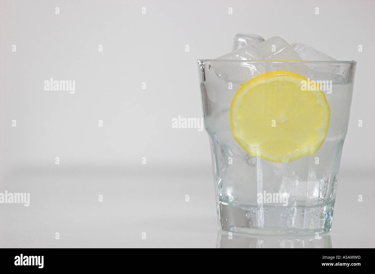 Glass of water with ice and a lemon slice Stock Photo - Alamy